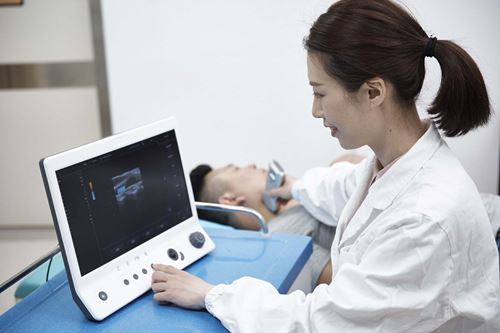 Using implants powered by ultrasound to diagnose and treat diseases